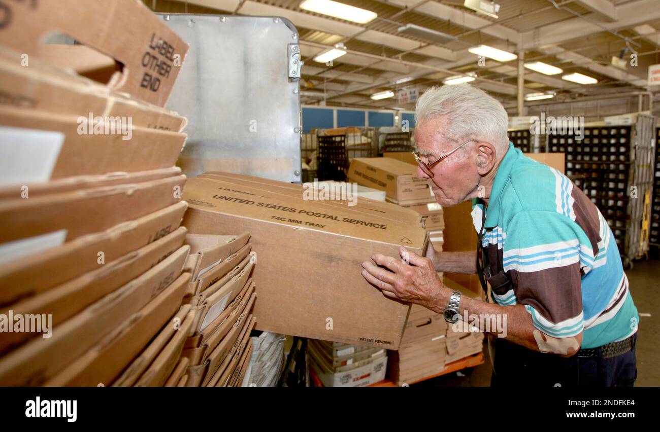 Chester Reed, 95, gathers postal cardboard boxes at a distribution ...