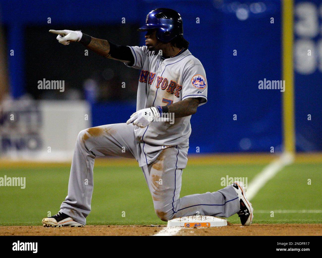 New York Mets' Jose Reyes gestures from third base after hitting an RBI ...