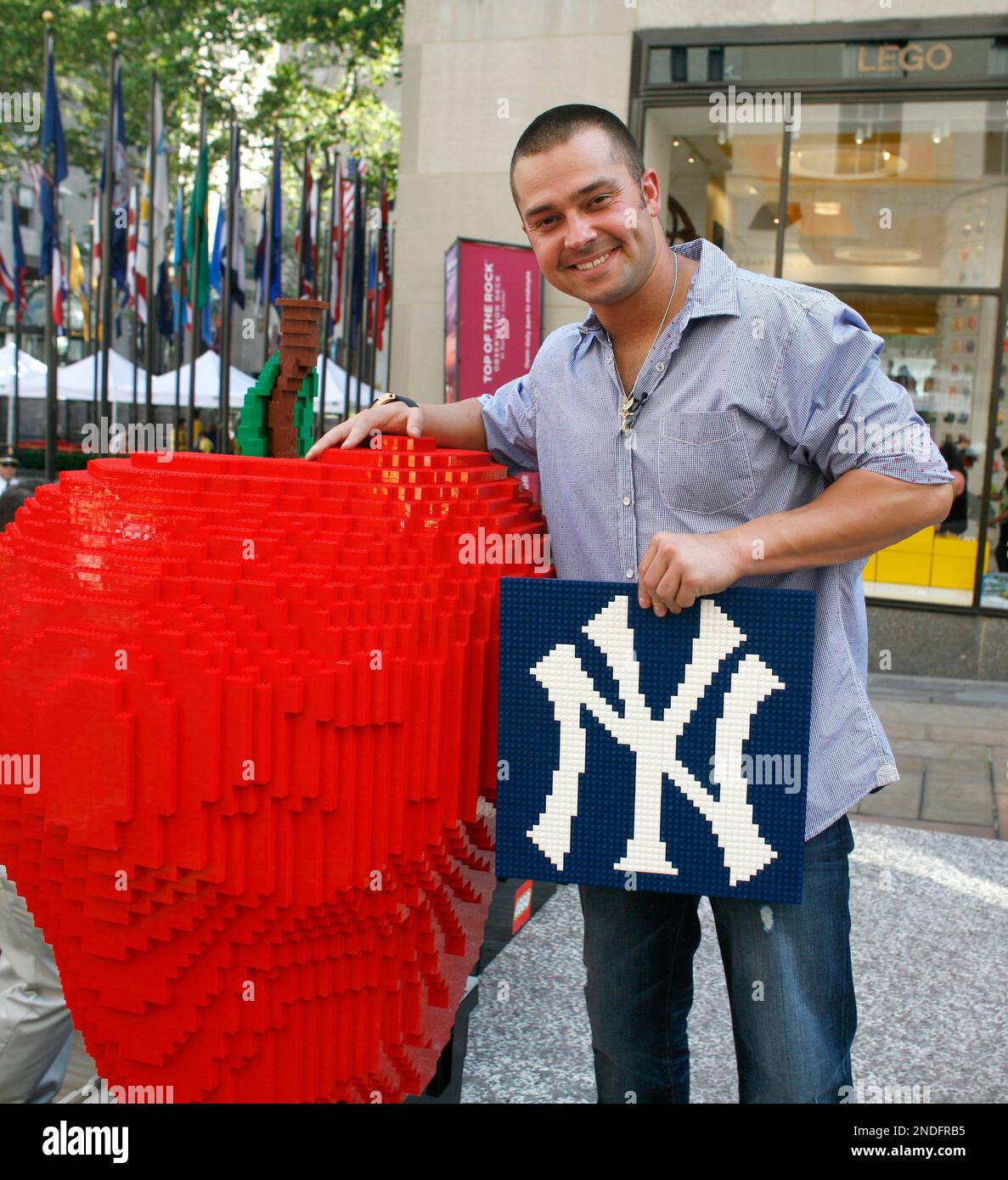 New York Yankees right fielder Nick Swisher poses with a LEGO apple and ...