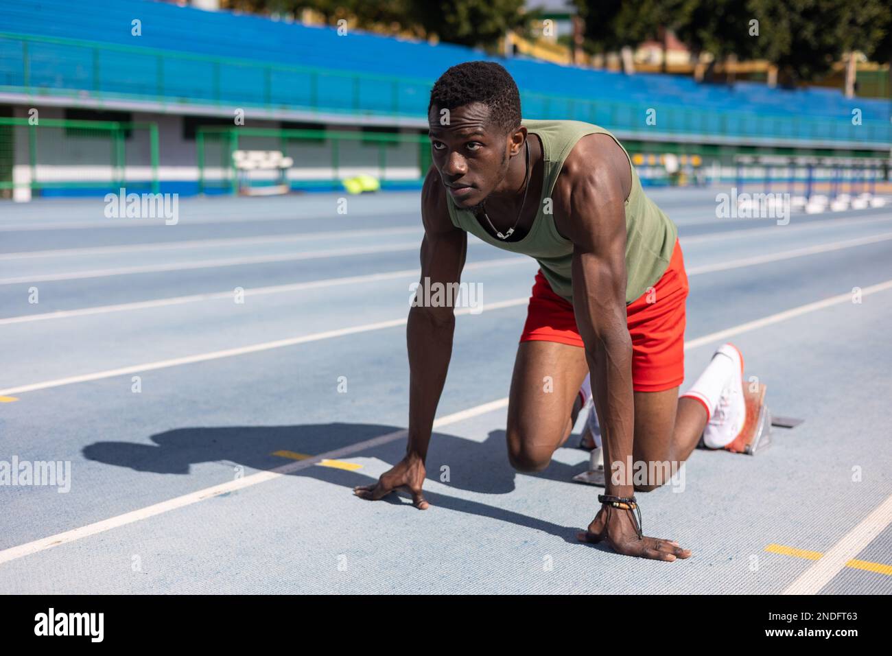 African runner in starting position on athletics track Stock Photo - Alamy