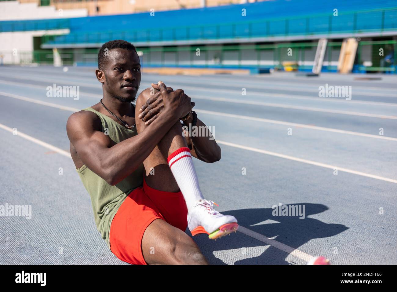 african athlete warming up on the athletics track Stock Photo - Alamy
