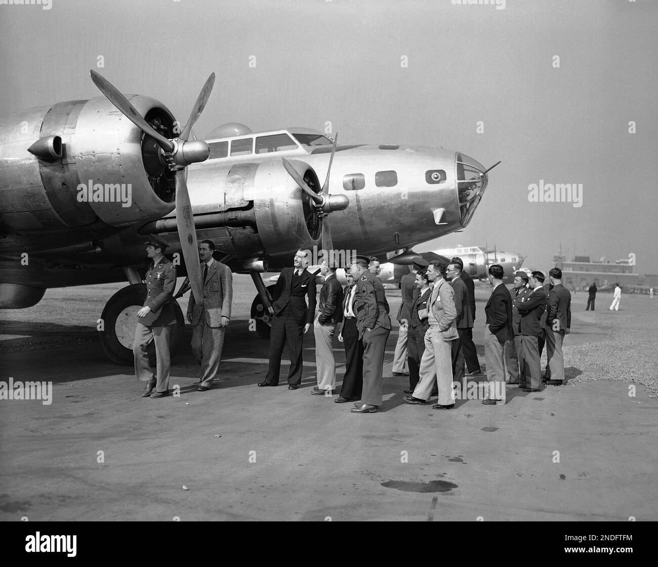 Uniformed United States Army Air Corps members take a group of British ...