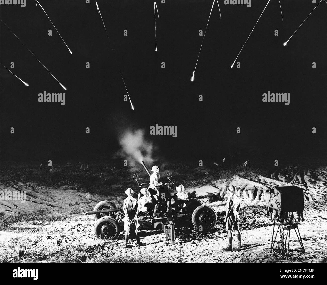 Firing at night, this gun crew from the First Composite Antiaircraft ...