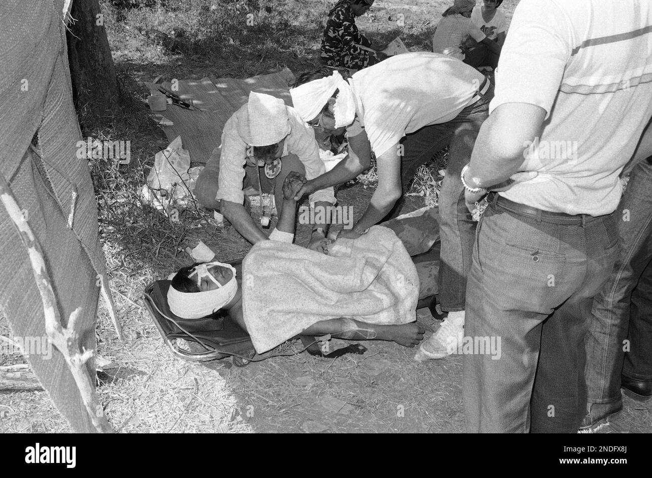 KPNLF guerrilla wounded by Vietnamese artillery is tender by the Red ...