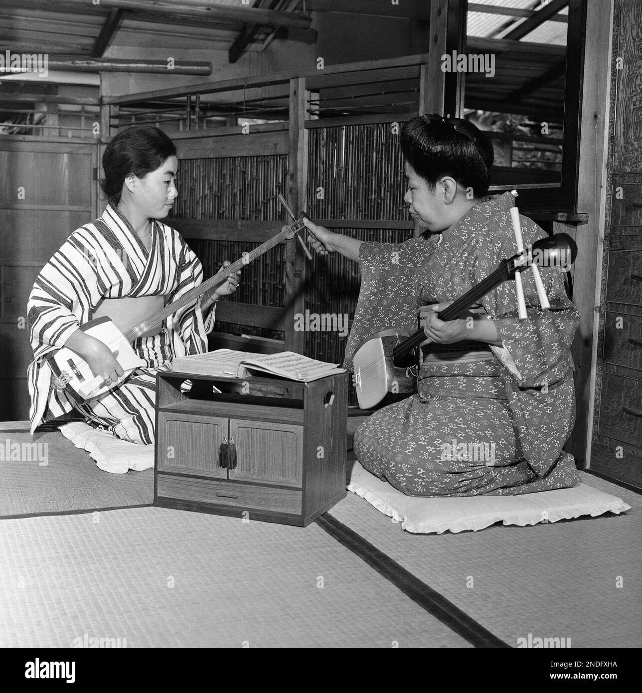 Part of the routine in the geisha's day is a lesson on a traditional ...