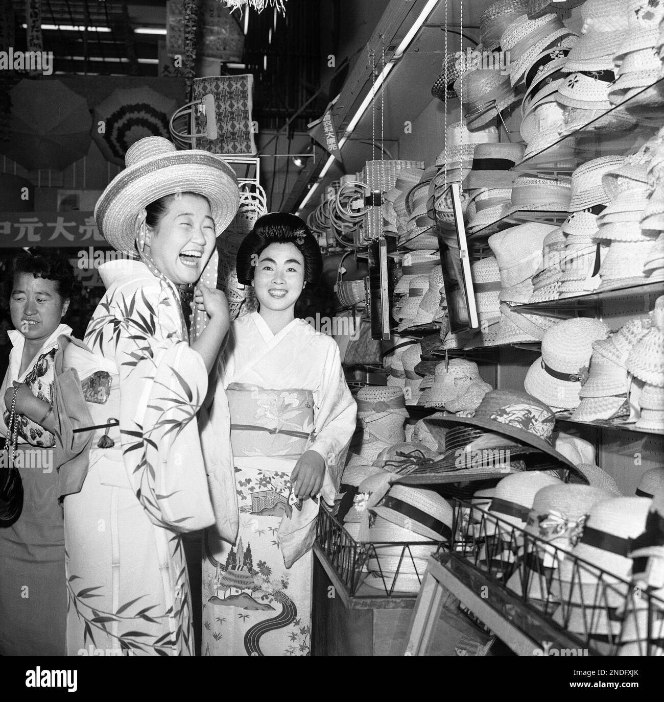Etsuko, right, now in the elaborate costume of her profession, enjoys ...