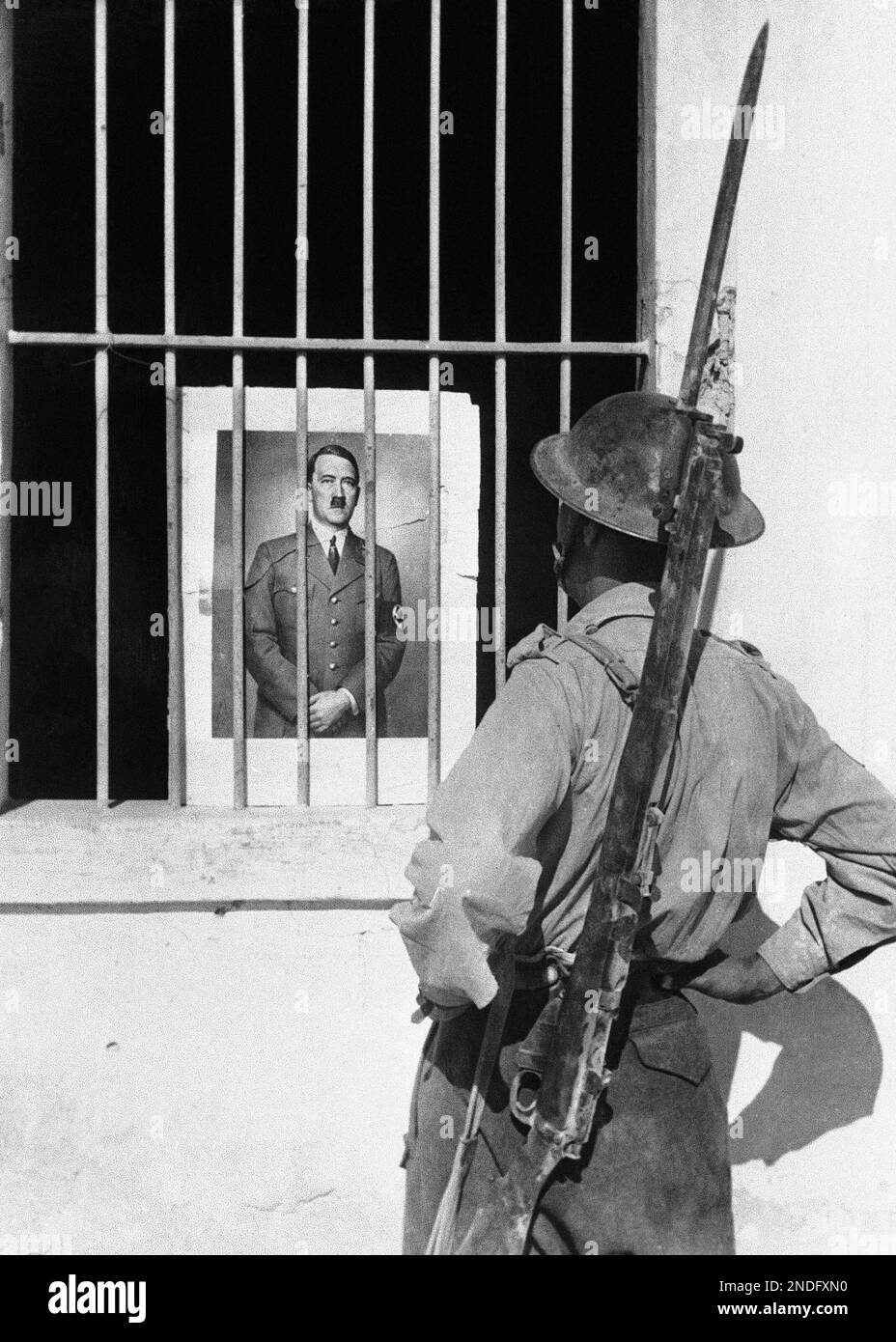 A British soldier, hands on hips and his bayoneted rifle slung on his ...