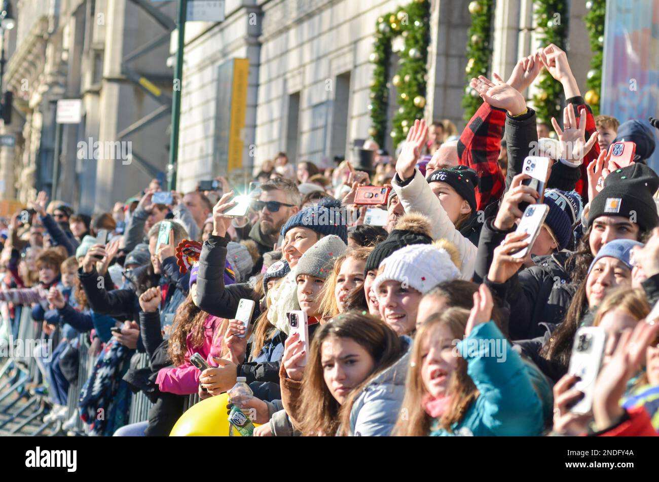 A crowd of people enjoying the Macy's Thanksgiving day parade along ...