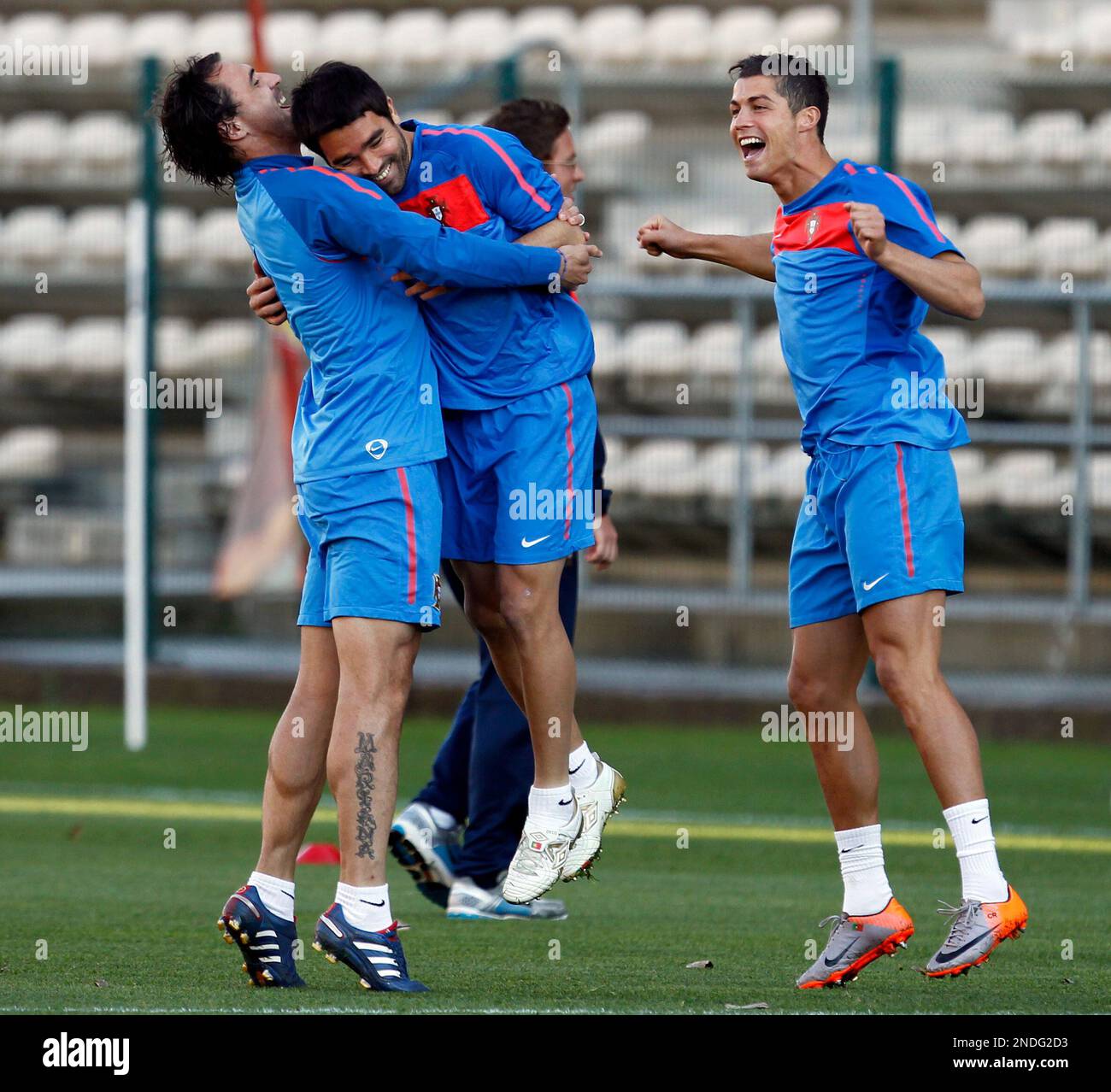 Portugal's Hugo Almeida, left, lifts up teammate Deco as Cristiano ...