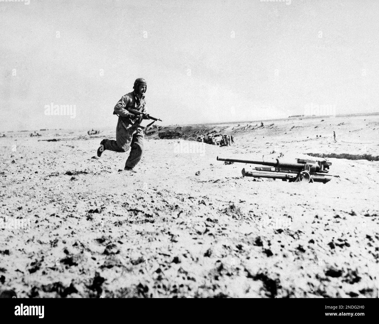 An American soldier, with rifle ready for any emergency, runs past a ...
