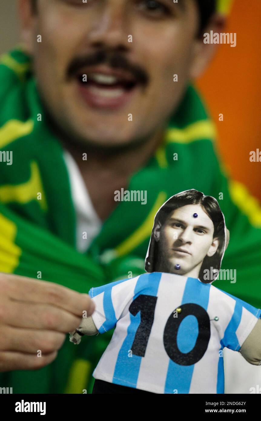 A Mexico supporter holds up a doll of Argentina's Lionel Messi before ...