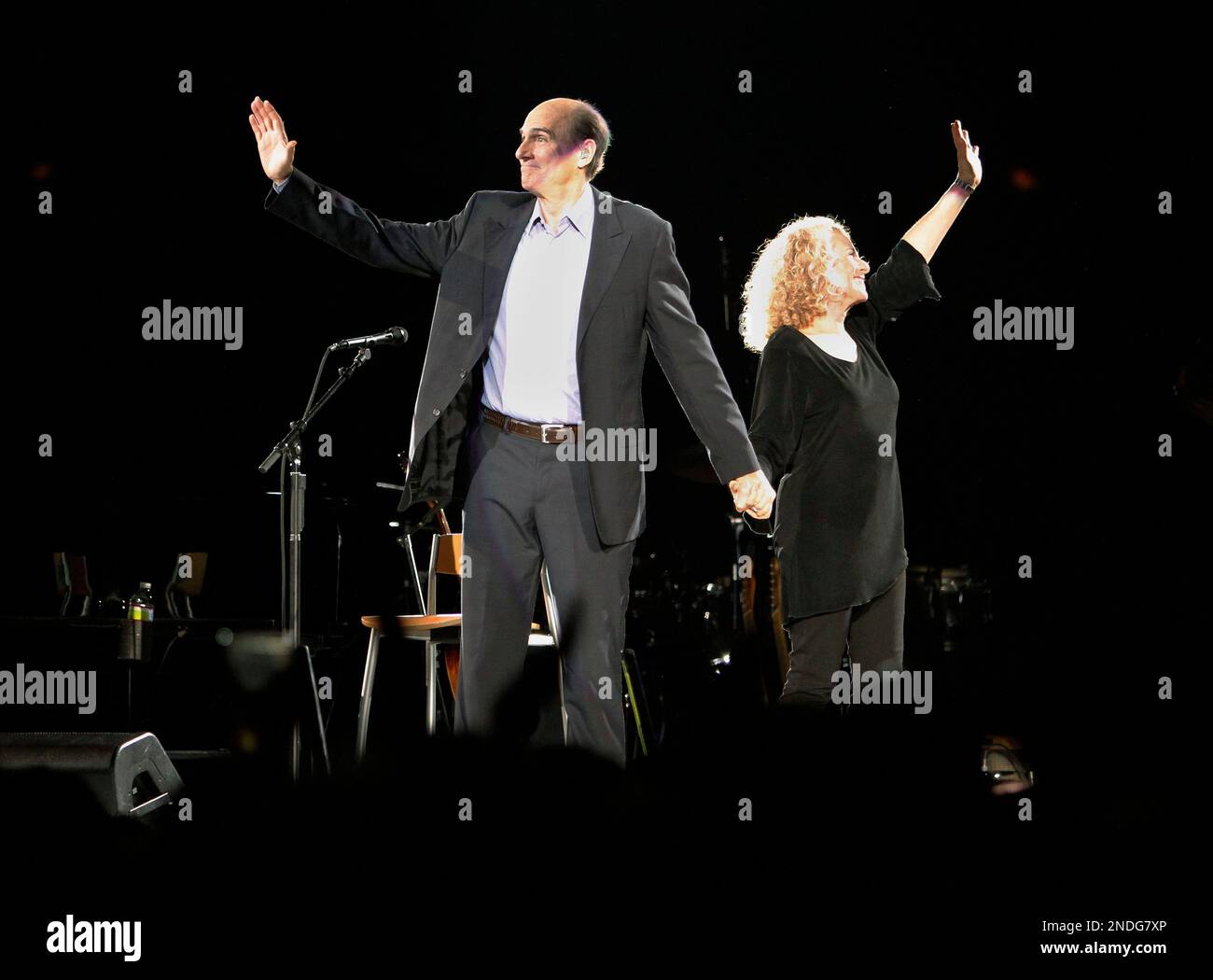 James Taylor, left, and Carole King wave to the crowd as they take the ...