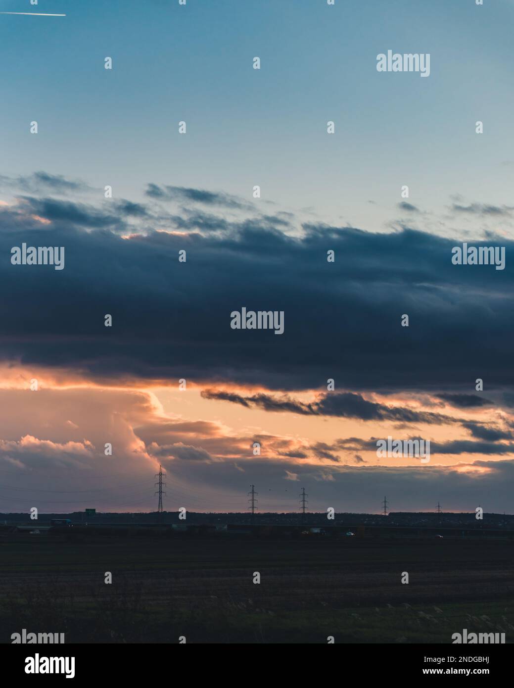 A beautiful view of a sky with clouds during sunset over field Stock ...