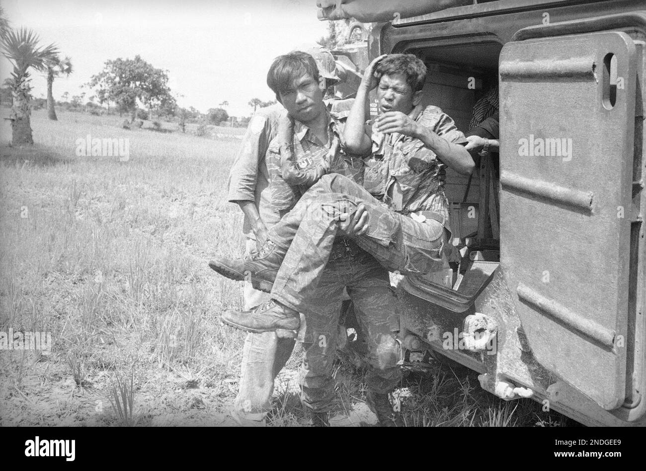 Wounded by rebel mortar barrage, a Cambodian soldier winces with pain ...