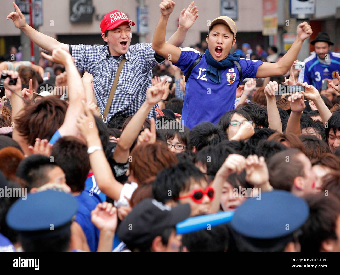 Japanese soccer fans celebrate after Japan's win over Denmark at World ...