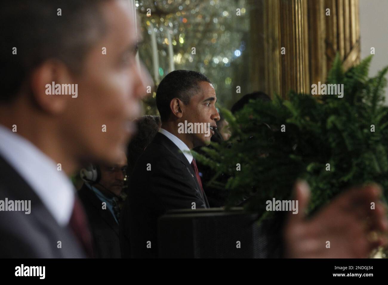 President Barack Obama is seen reflected in a mirror during his joint ...