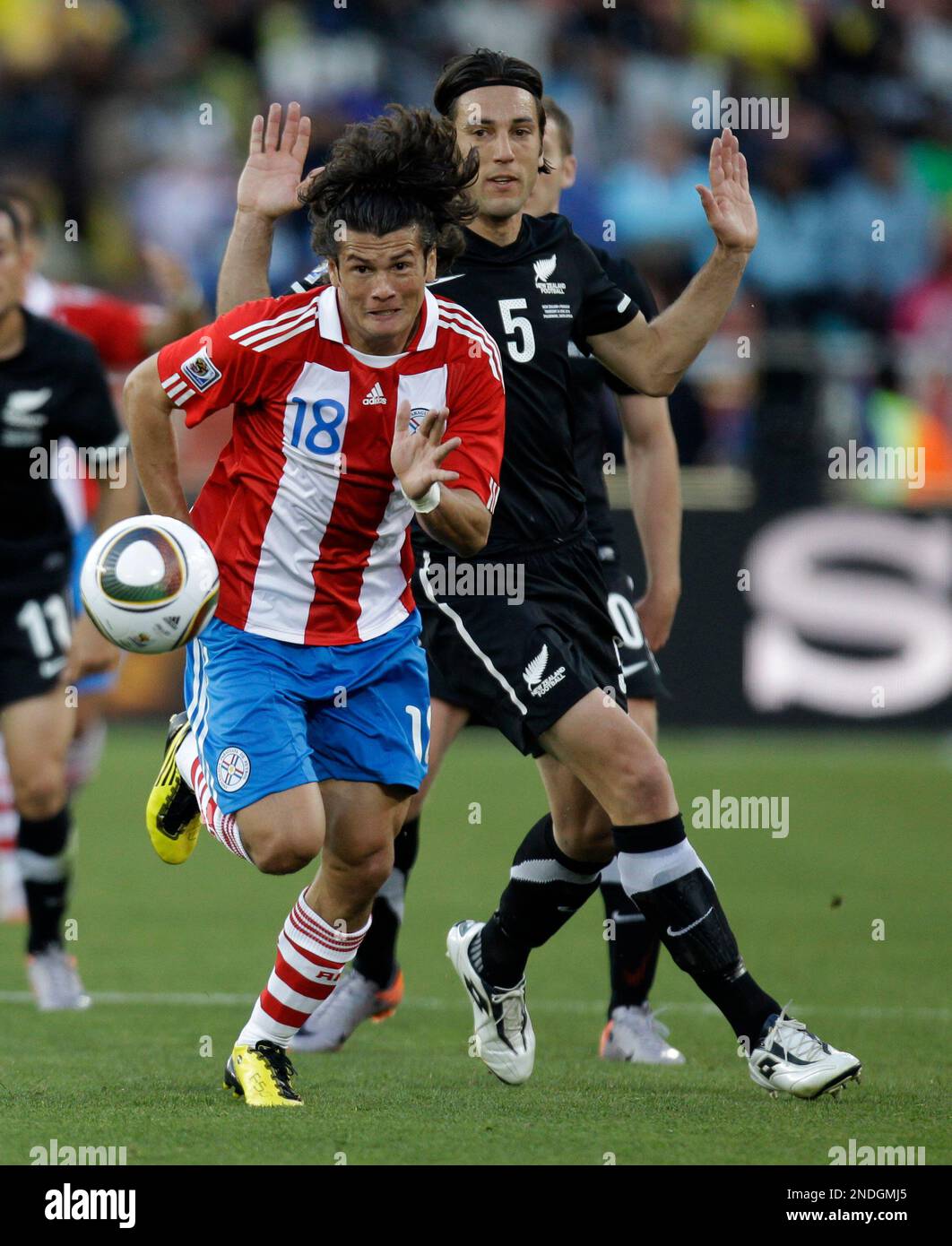 Paraguay's Nelson Haedo Valdez, front, goes for the ball as New Zealand ...