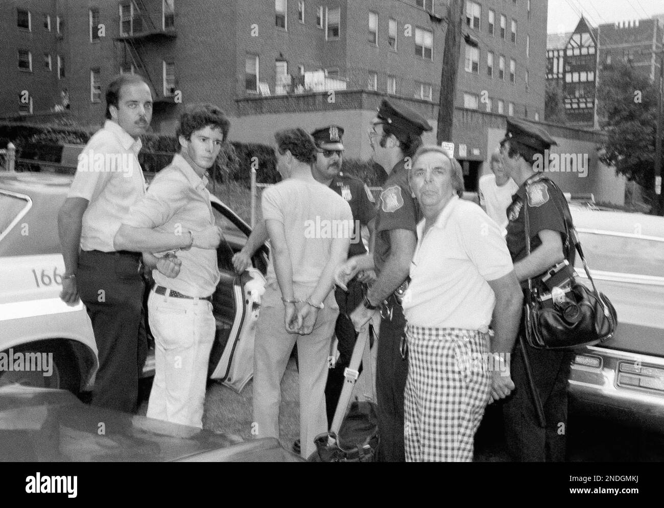 New York Daily News photographer Leonard Detrick, right in checkered ...