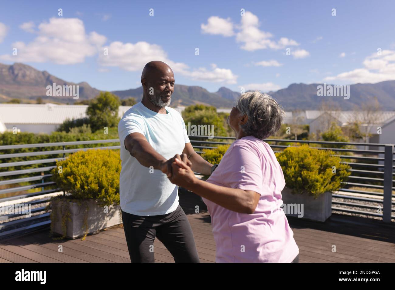 African american senior couple dancing together on the terrace at home ...
