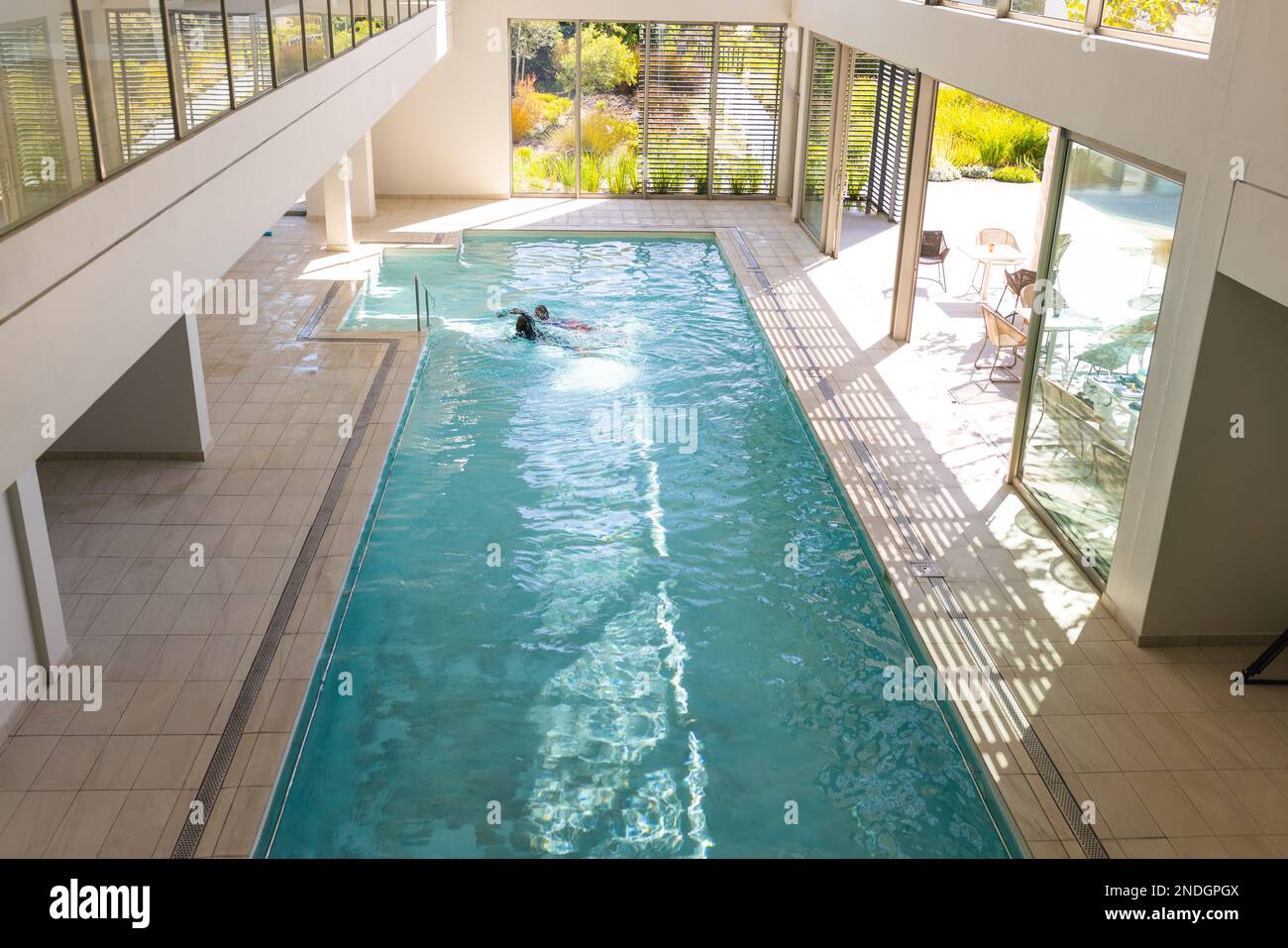 Aerial view of african american senior couple swimming together in the ...
