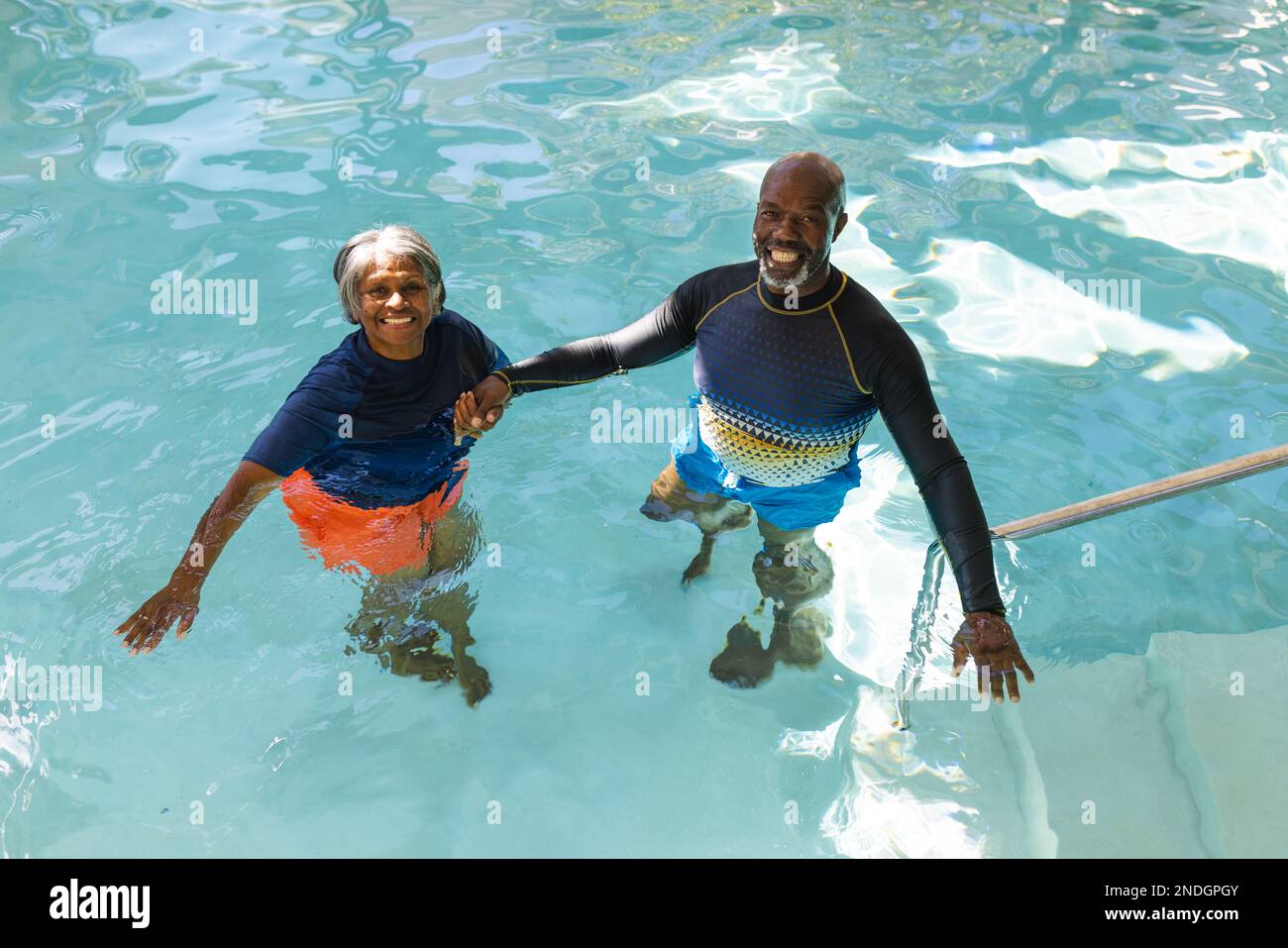 Portrait of african american senior couple smiling in the swimming pool ...