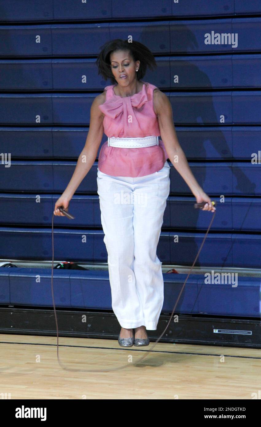 First lady Michelle Obama uses a jump- rope during exercise activities ...