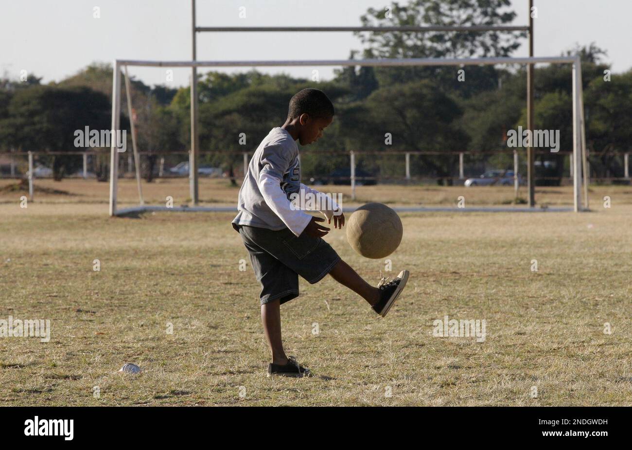 A young South African boy plays with soccer ball in Rustenburg, South ...