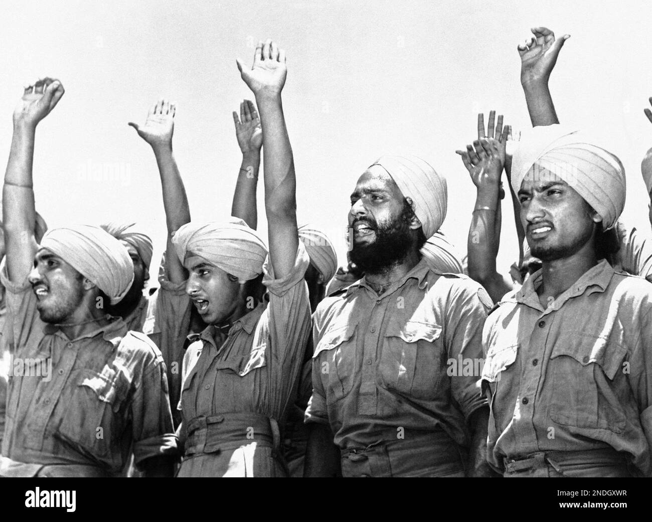 Turbaned British Indian troops raise their arms and give a war-cry ...