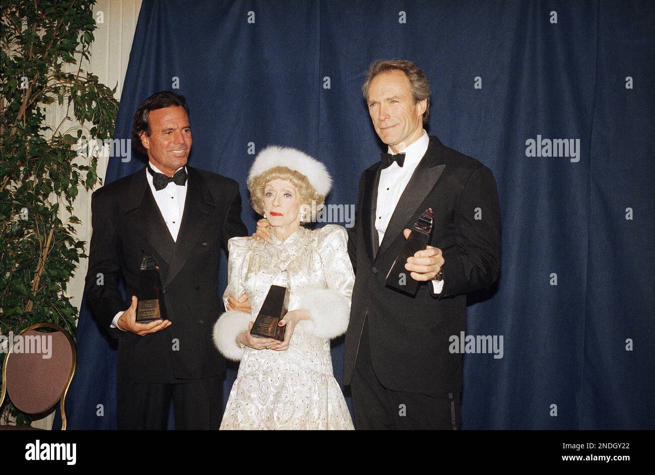 Julio Iglesias, left, Bette Davis and Clint Eastwood hold their ...