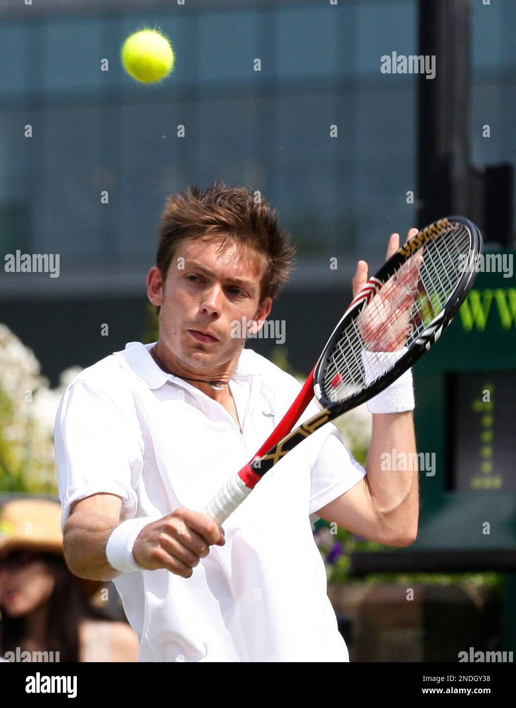 France's Nicolas Mahut makes a backhand return to John Isner of the ...