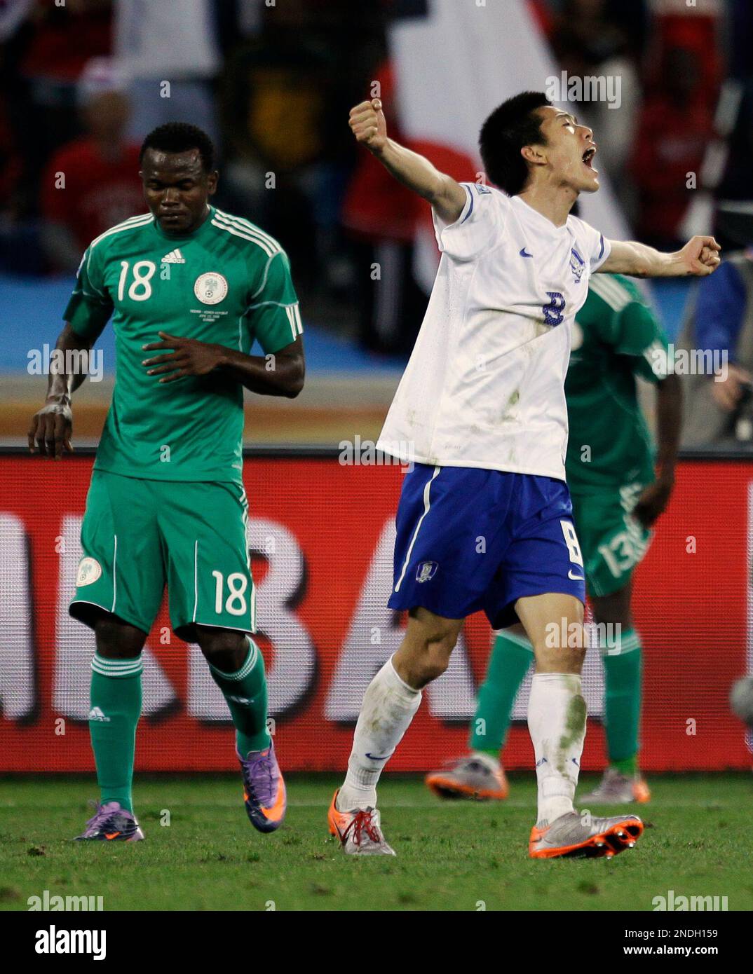 Nigeria's Victor Obinna, left, walks on as South Korea's Kim Jung-woo ...