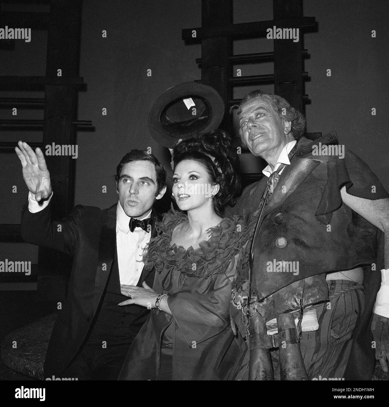 Actress Joan Collins is flanked by Anthony Newly, left, and Cyril ...