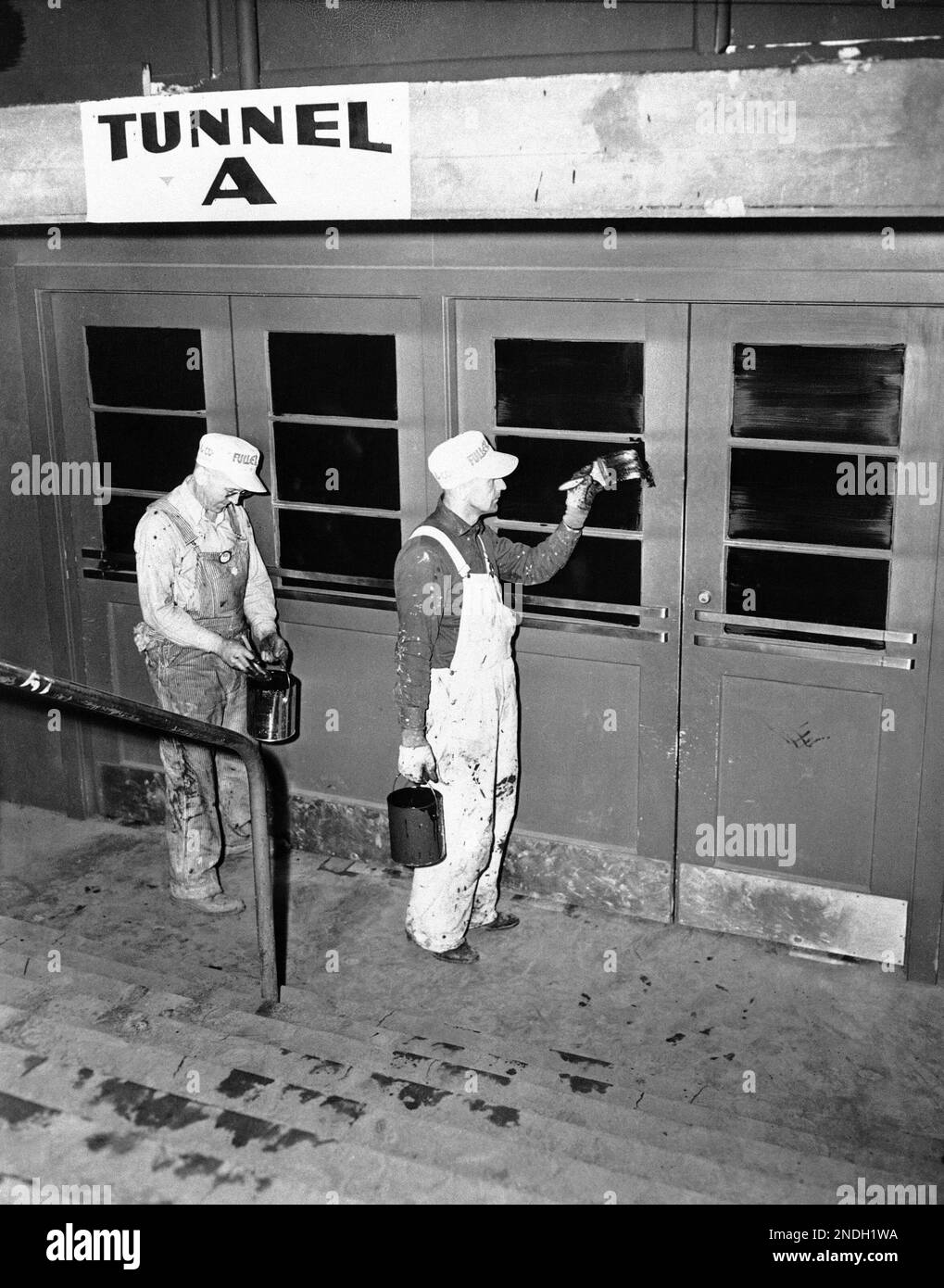 Finishing touches of blackout paint are put on the main building of the ...
