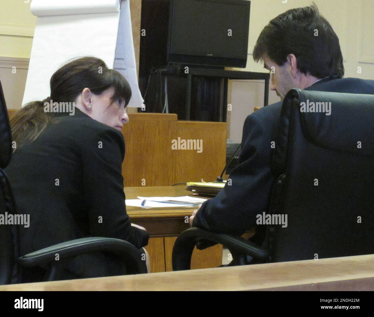 Defense attorney Brandi Studer, left, confers with James Kraig Kahler ...