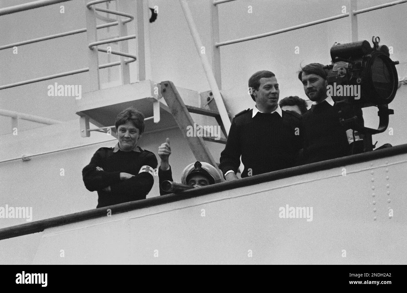 A British crewman of the HMS Hecla gives the thumbs up sign of okay as ...