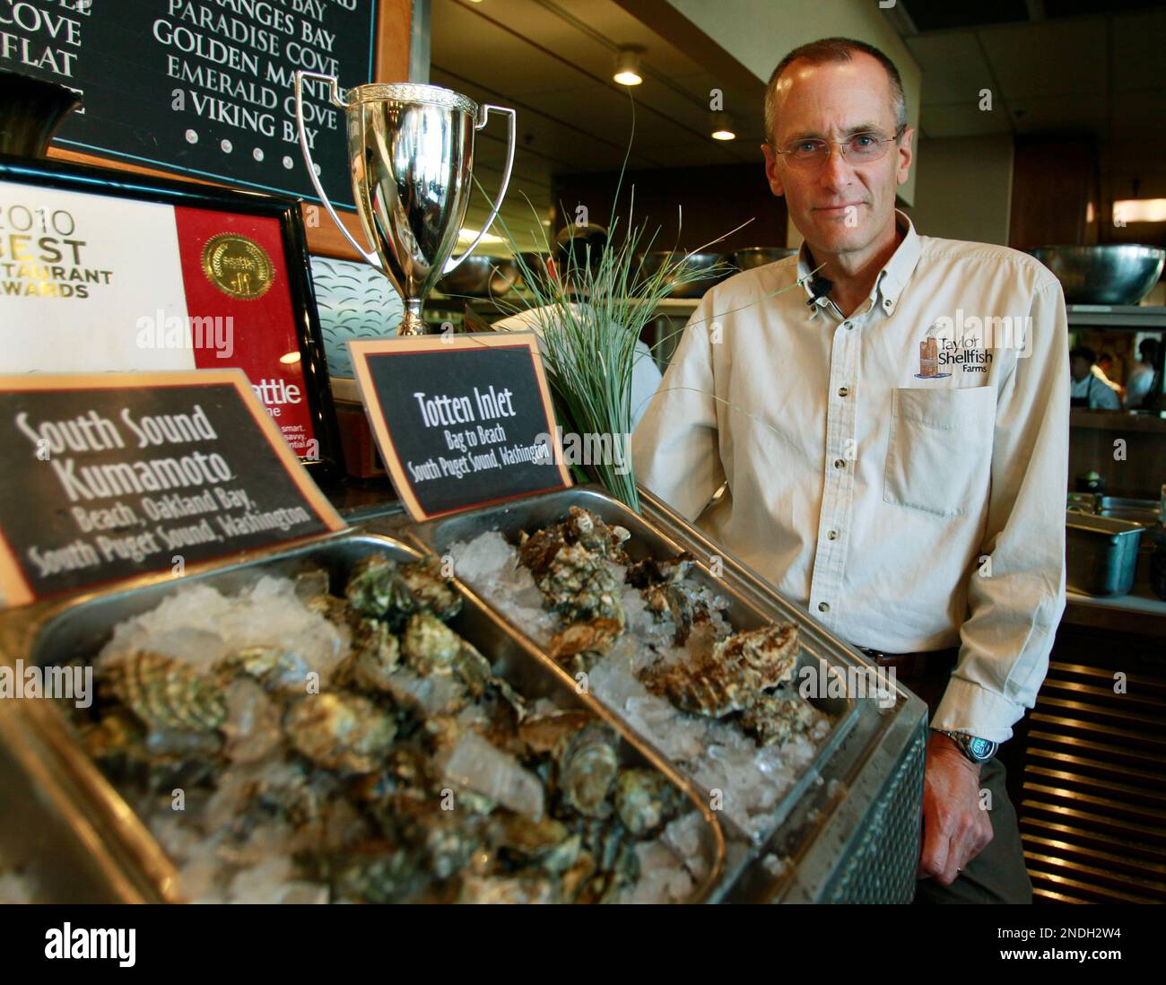 Bill Dewey, of the Taylor Shellfish Co., poses at Elliott Oyster House ...
