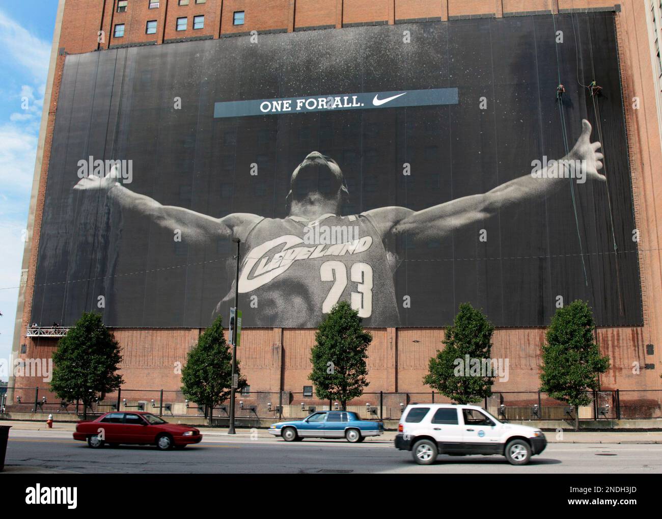 Workers clean the giant banner of Cleveland Cavaliers star LeBron James ...