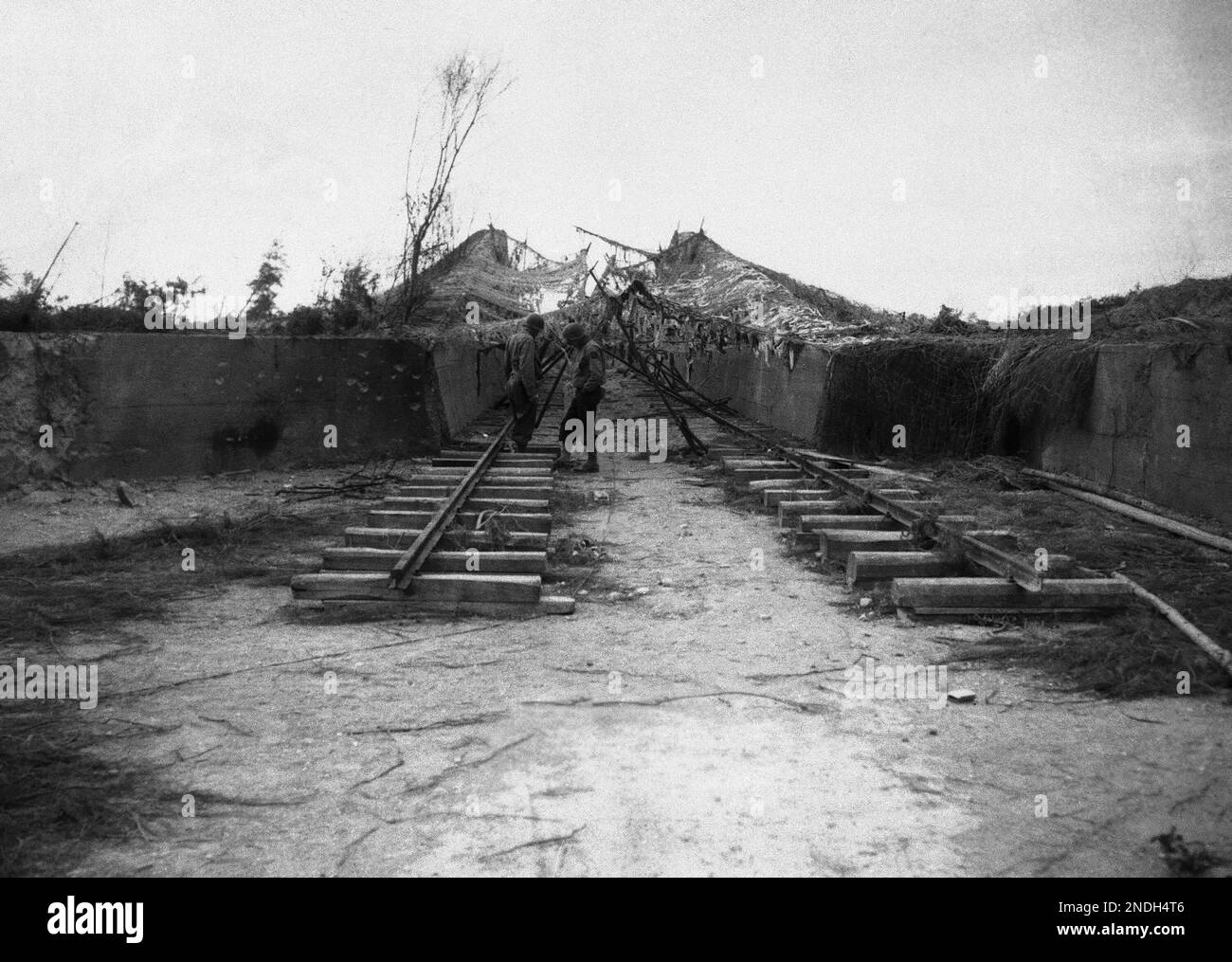 Looking up the camouflaged ramp with blast wall on either side of a ...