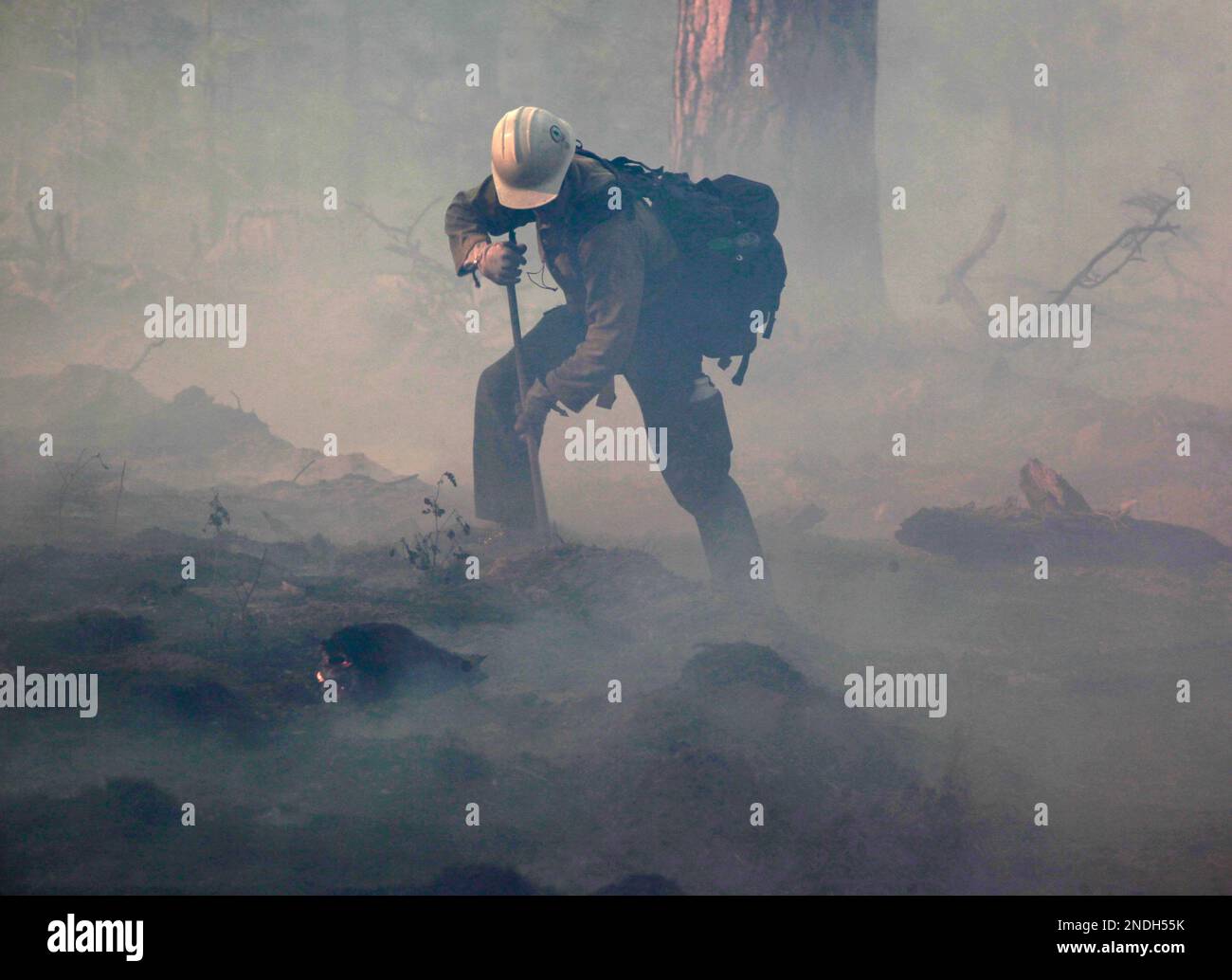 John Meyer, of the Boise Hot Shots, works the Schultz Fire fire line ...