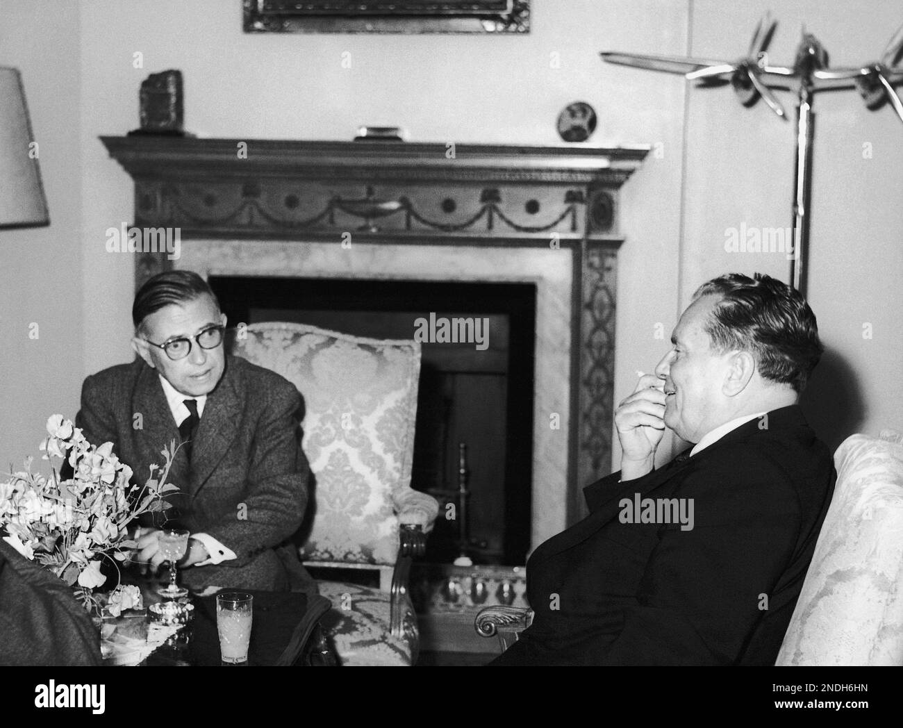 President of Yugoslavia Josip Broz Tito, right, smokes a cigarette ...