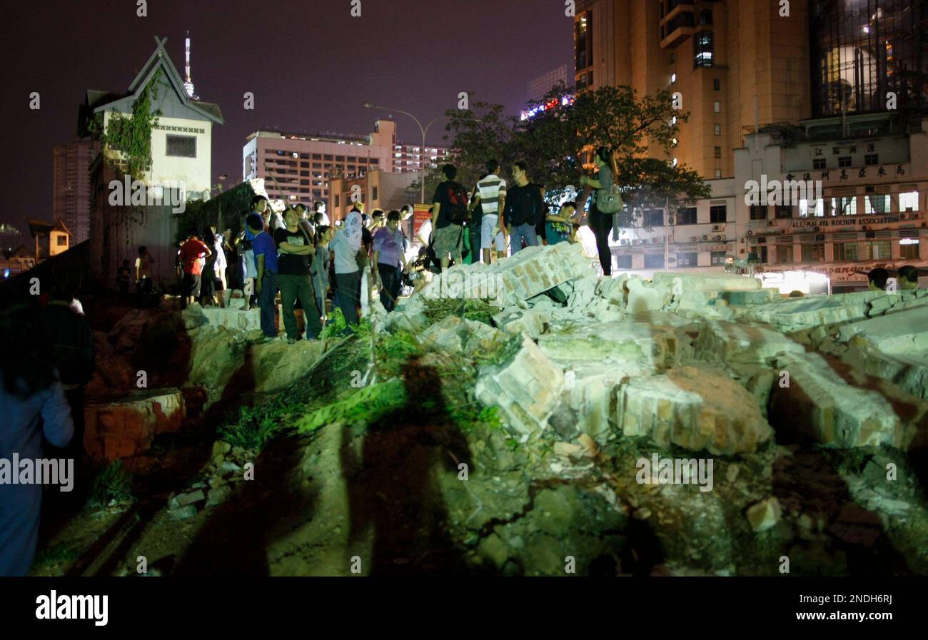 Malaysian stand on a demolished wall of Pudu Prison in downtown Kuala ...