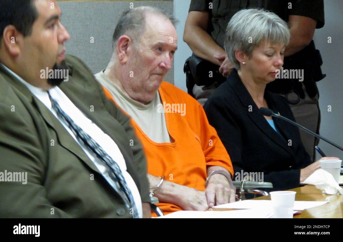 Confessed murderer Edward W. Edwards, center, sits handcuffed to his ...