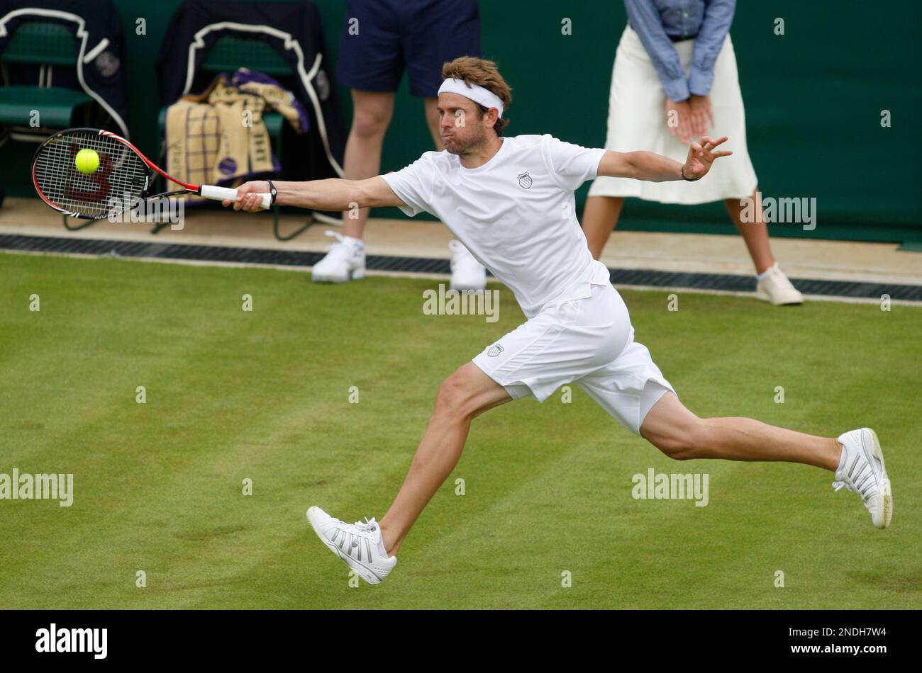 Mardy Fish of the US stretches for a shot from Australia's Bernard ...