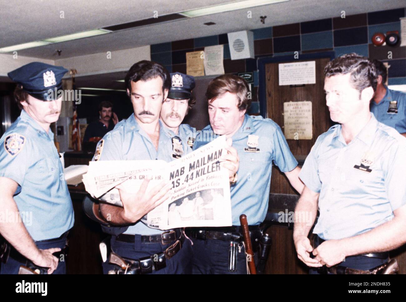 Policemen of the 84th precinct read about the arrest in Brooklyn ...
