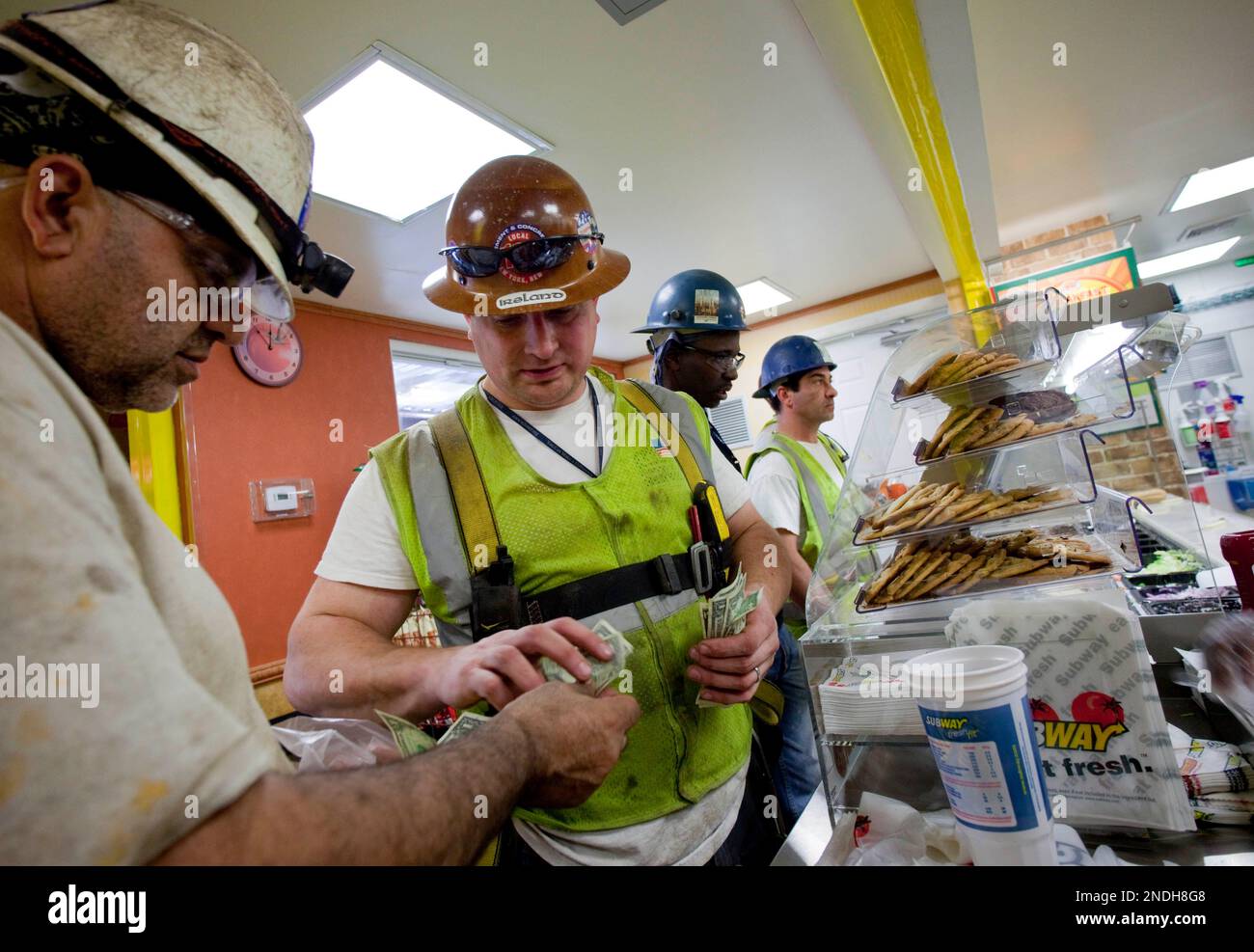 In this June 18, 2010 photo, Christopher Connolly, center, a cement ...
