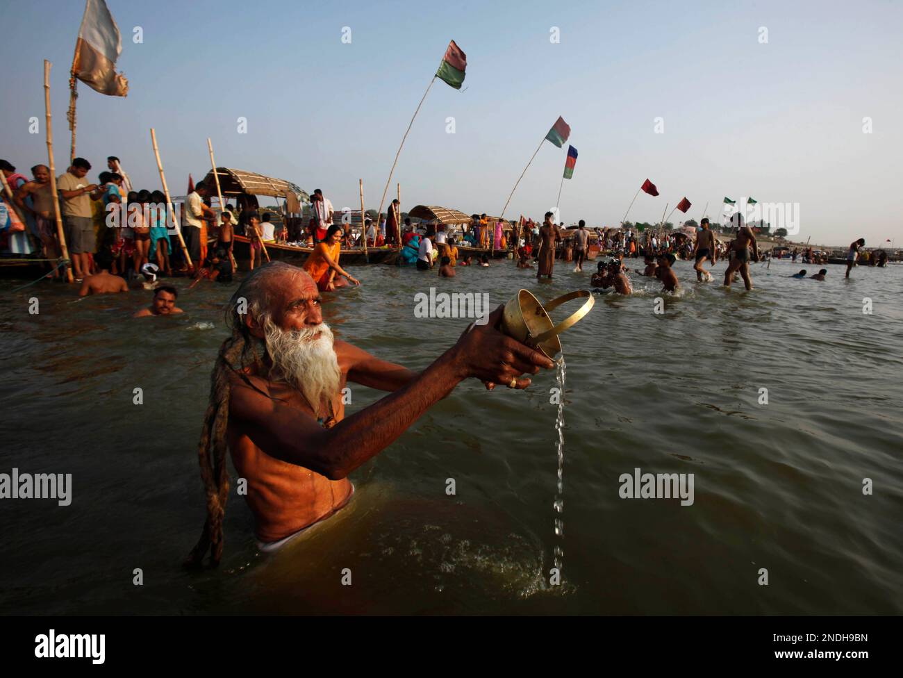 A Hindu holy man prays as he bathes in the River Ganges at Sangam, the ...