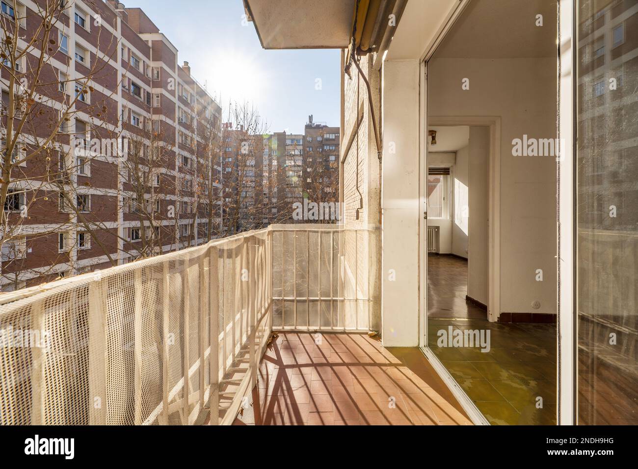 A terrace of a house with large glass and aluminum windows leading to ...