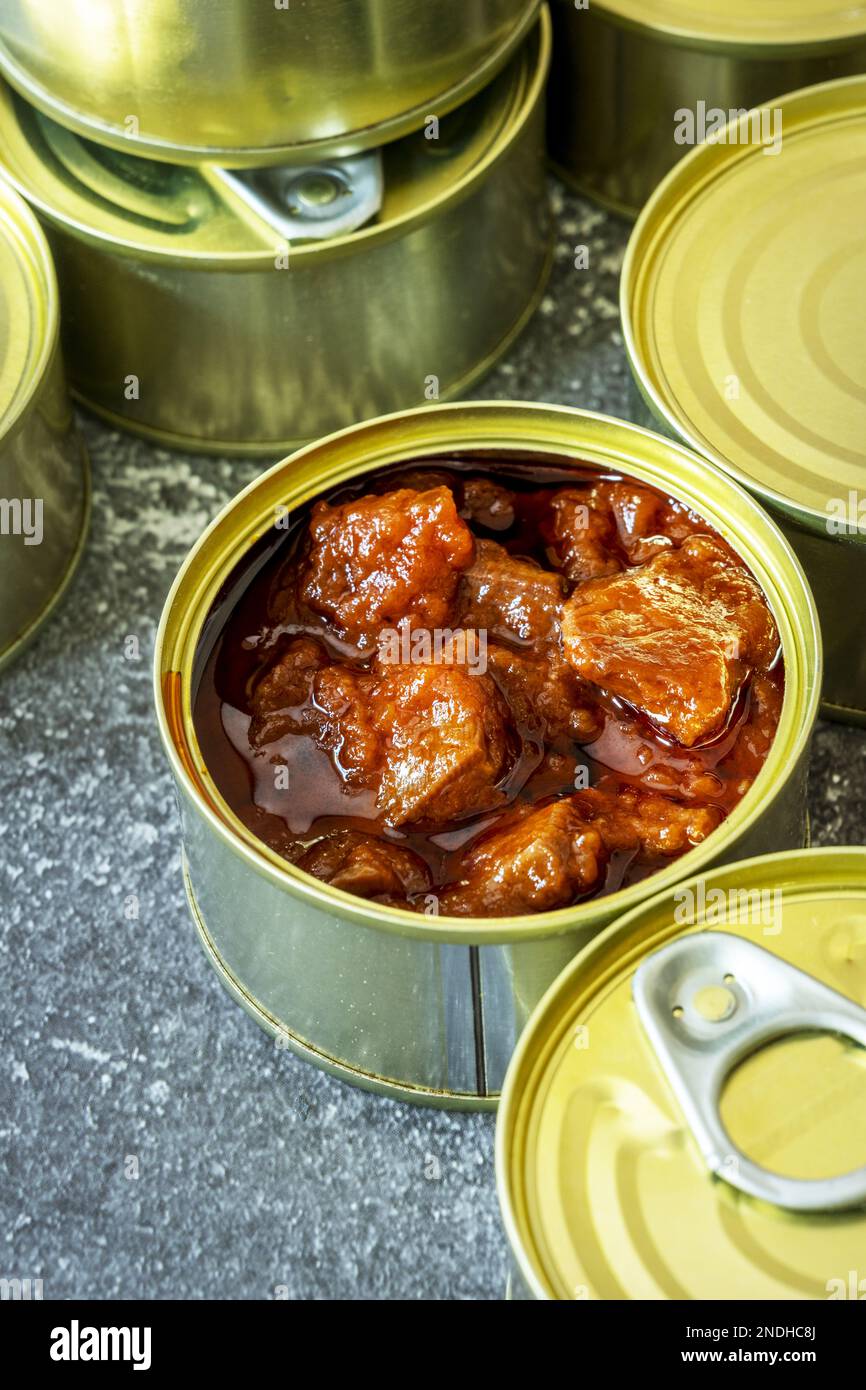 A set of circular cans of canned calamari stew with American sauce ...