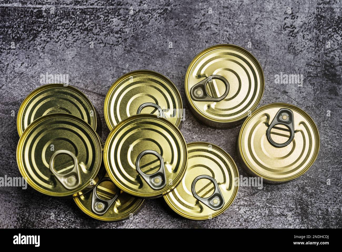 Set of small circular metal storage tins with easy open tabs on gray ...