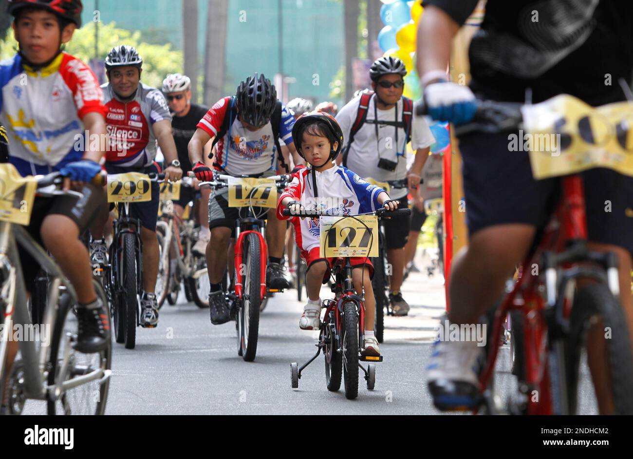 A Filipino boy joins others during a father and son bicycle run to ...